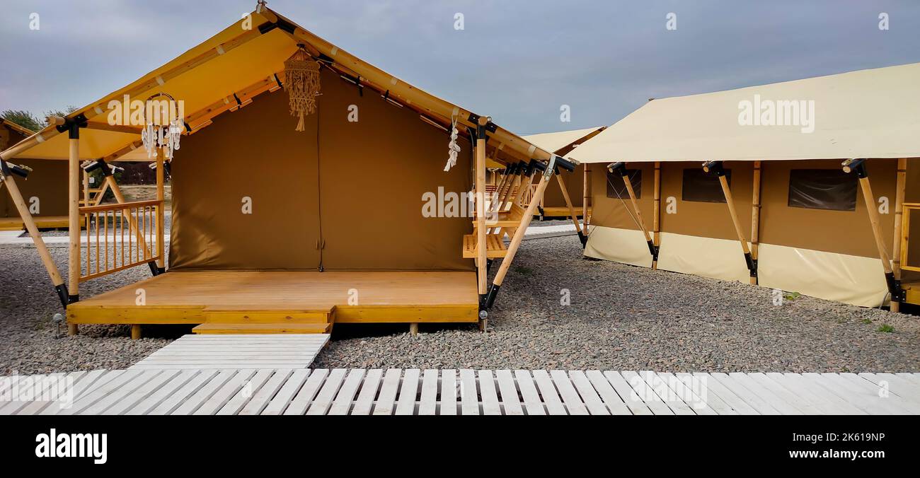 Large wooden framed tents with wooden walkways in a campground Stock ...