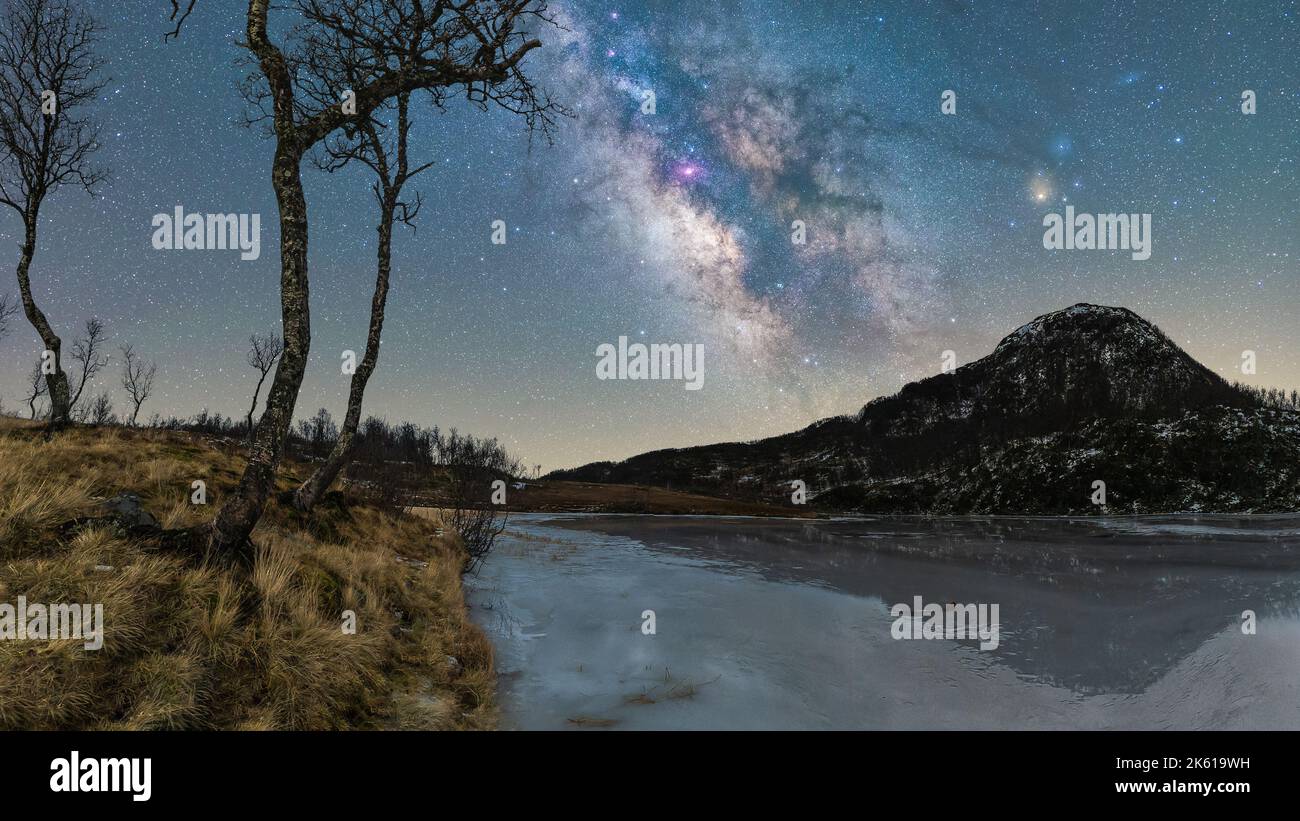 Amazing scenery of glowing stars of Milky Way in night sky over snowy ...