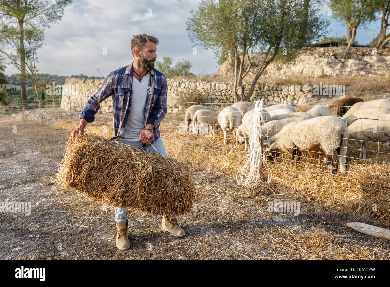 Full body of young bearded ethnic male farmer with dark hair in casual ...