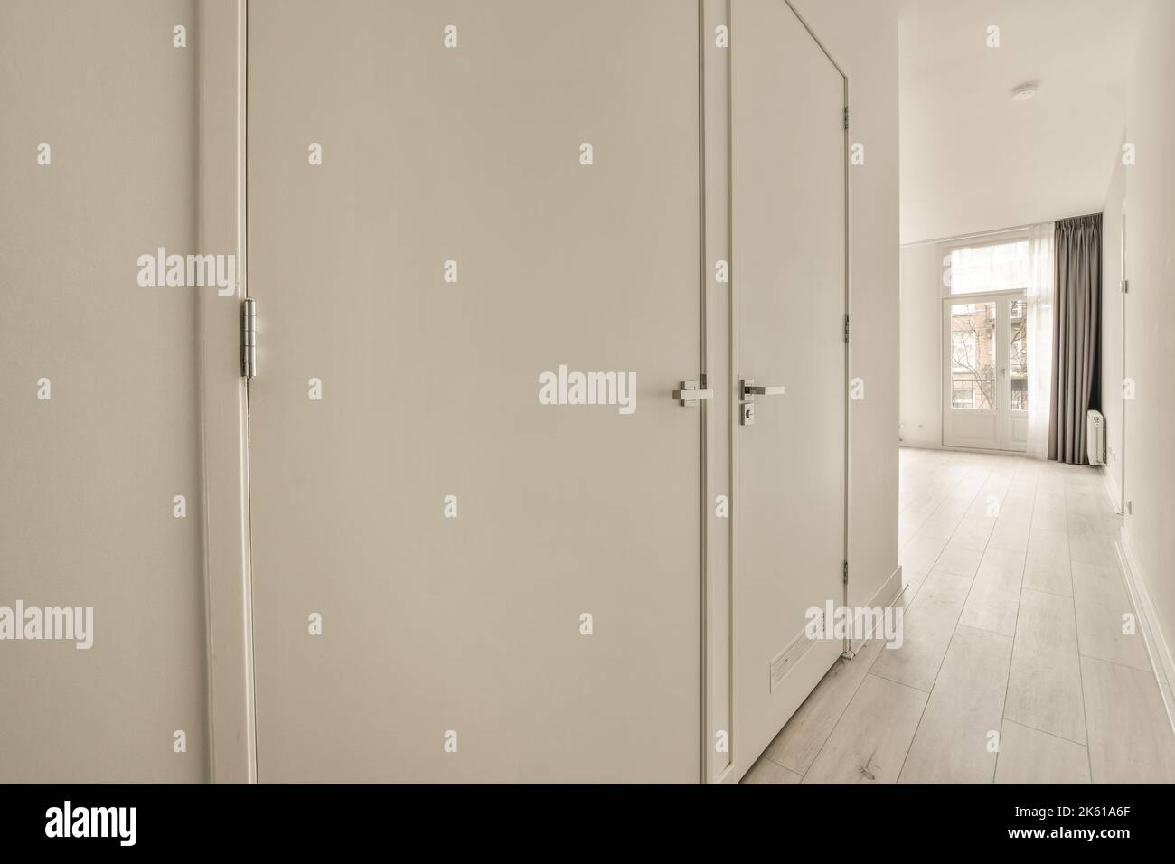 Light hallway of modern flat leading to room with window Stock Photo ...