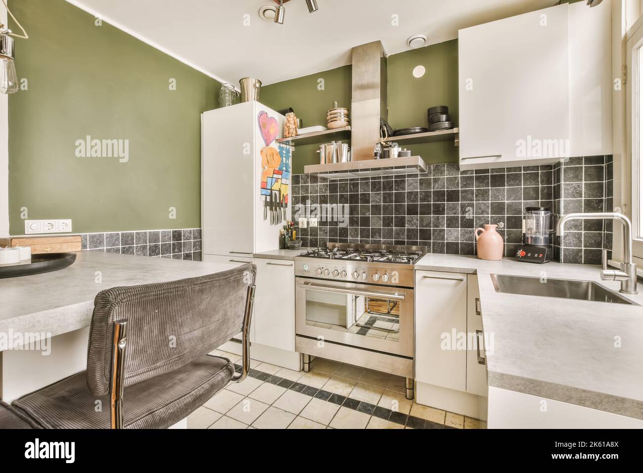 Counter with various supplies and sink placed in light kitchen with ...