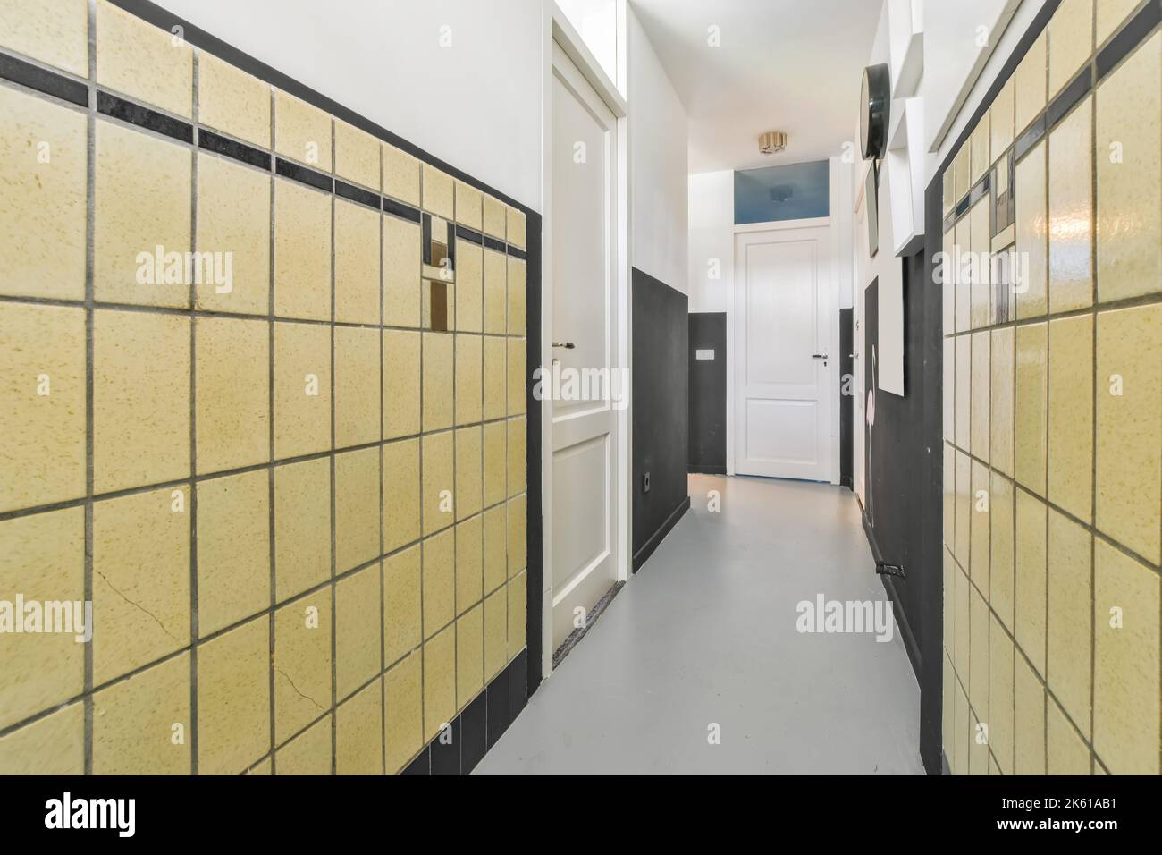 Interior passage way with different doors and tiled wall Stock Photo - Alamy