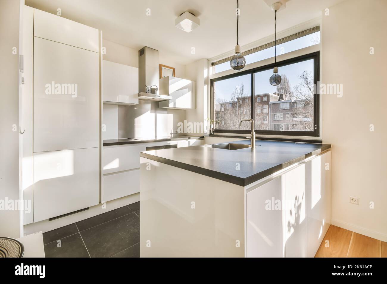 Counter with sink placed in light modern kitchen with white furniture ...