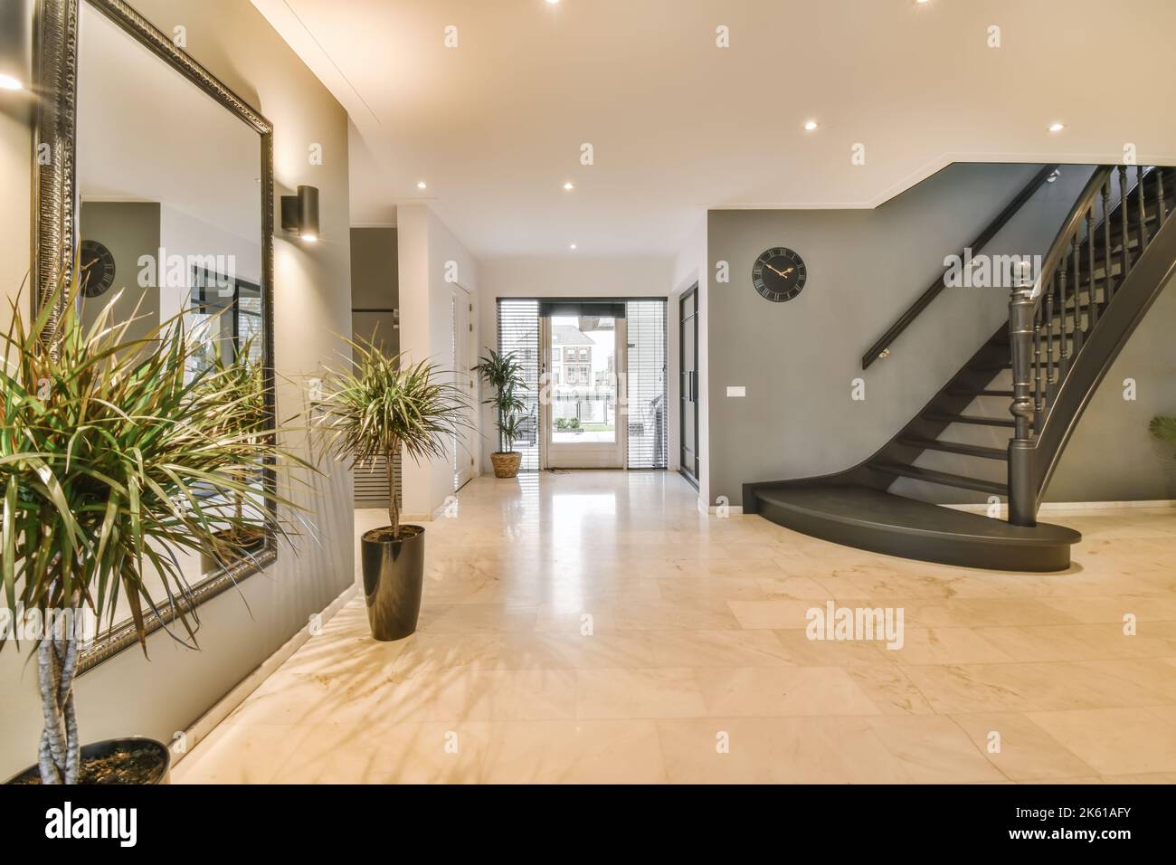 Interior of hallway at entrance of modern big home with stairway ...