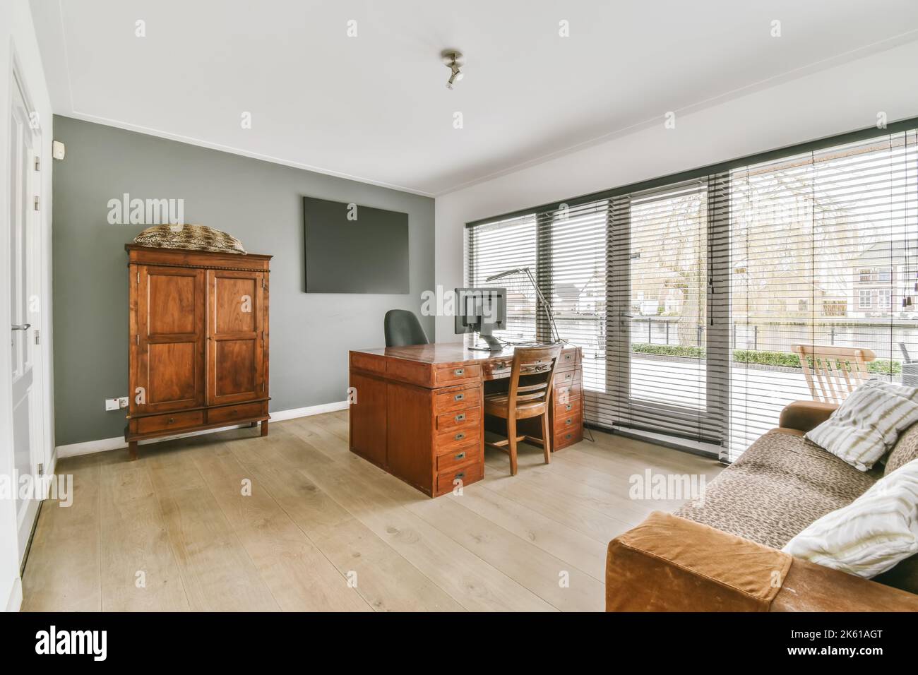 Interior of workplace in residential house with wooden desk with ...