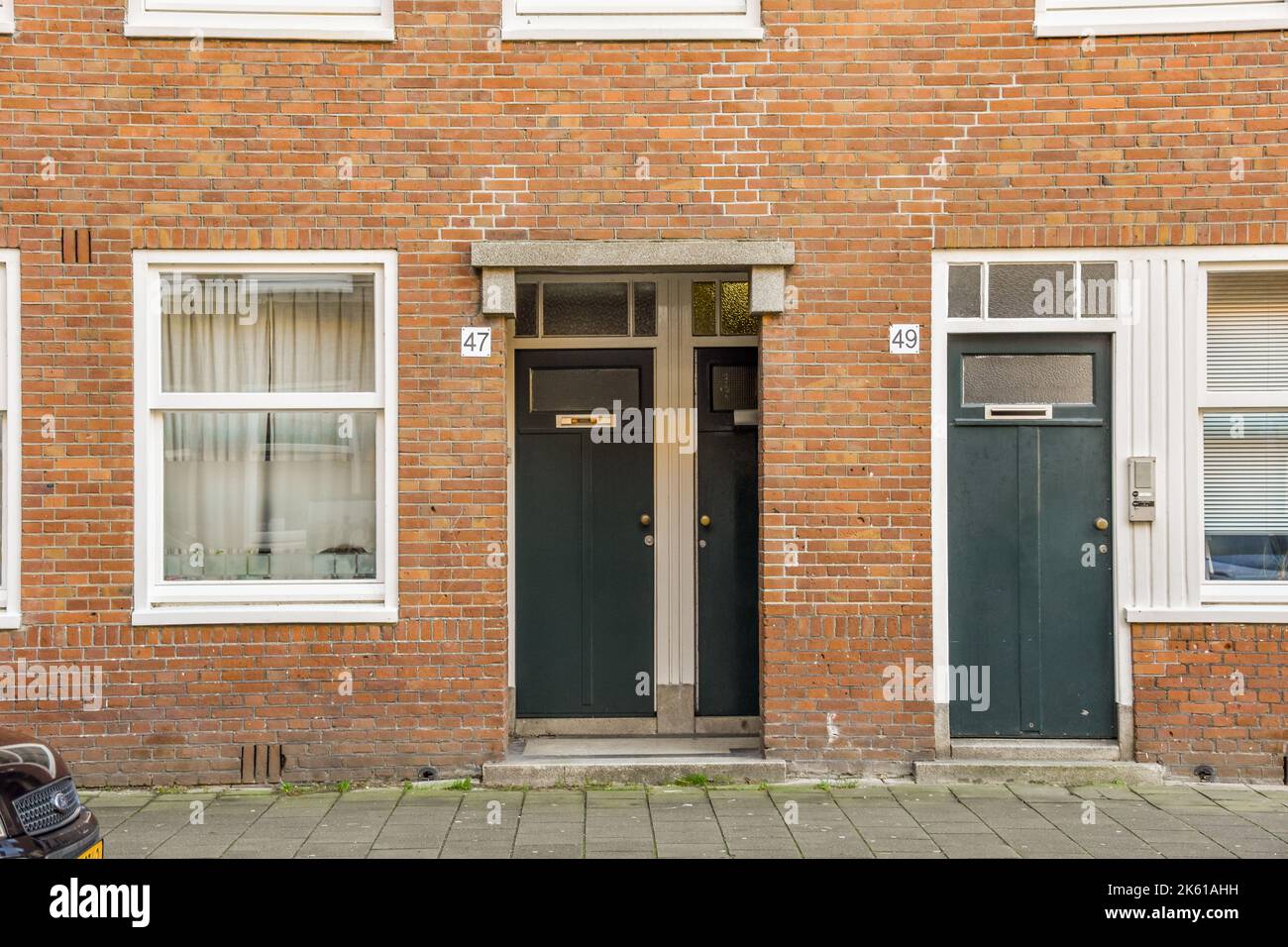 Building exterior door entrance with brick wall and windows along ...