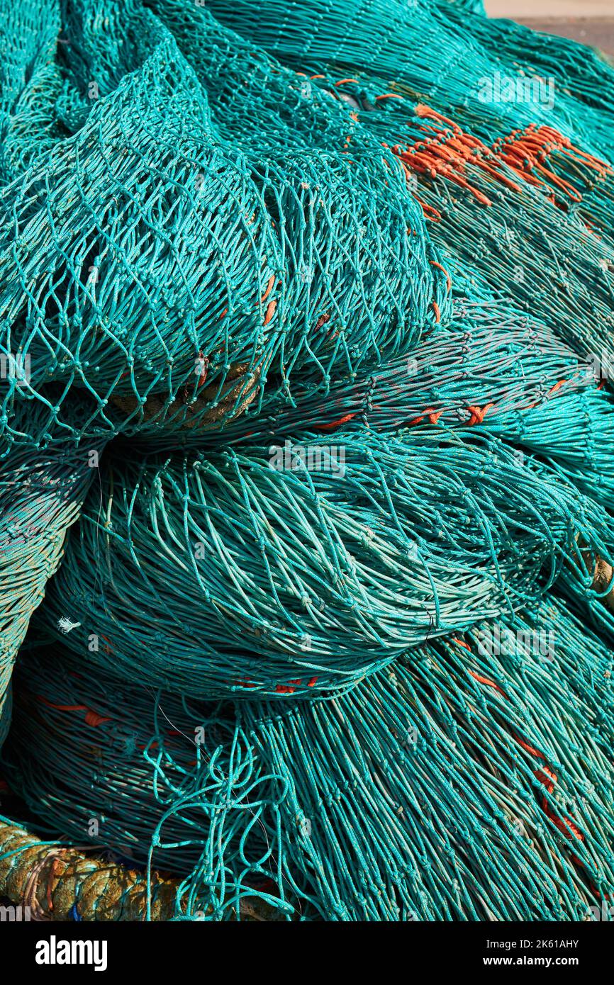 Bunch of fishing colorful nets in daytime in port Stock Photo - Alamy