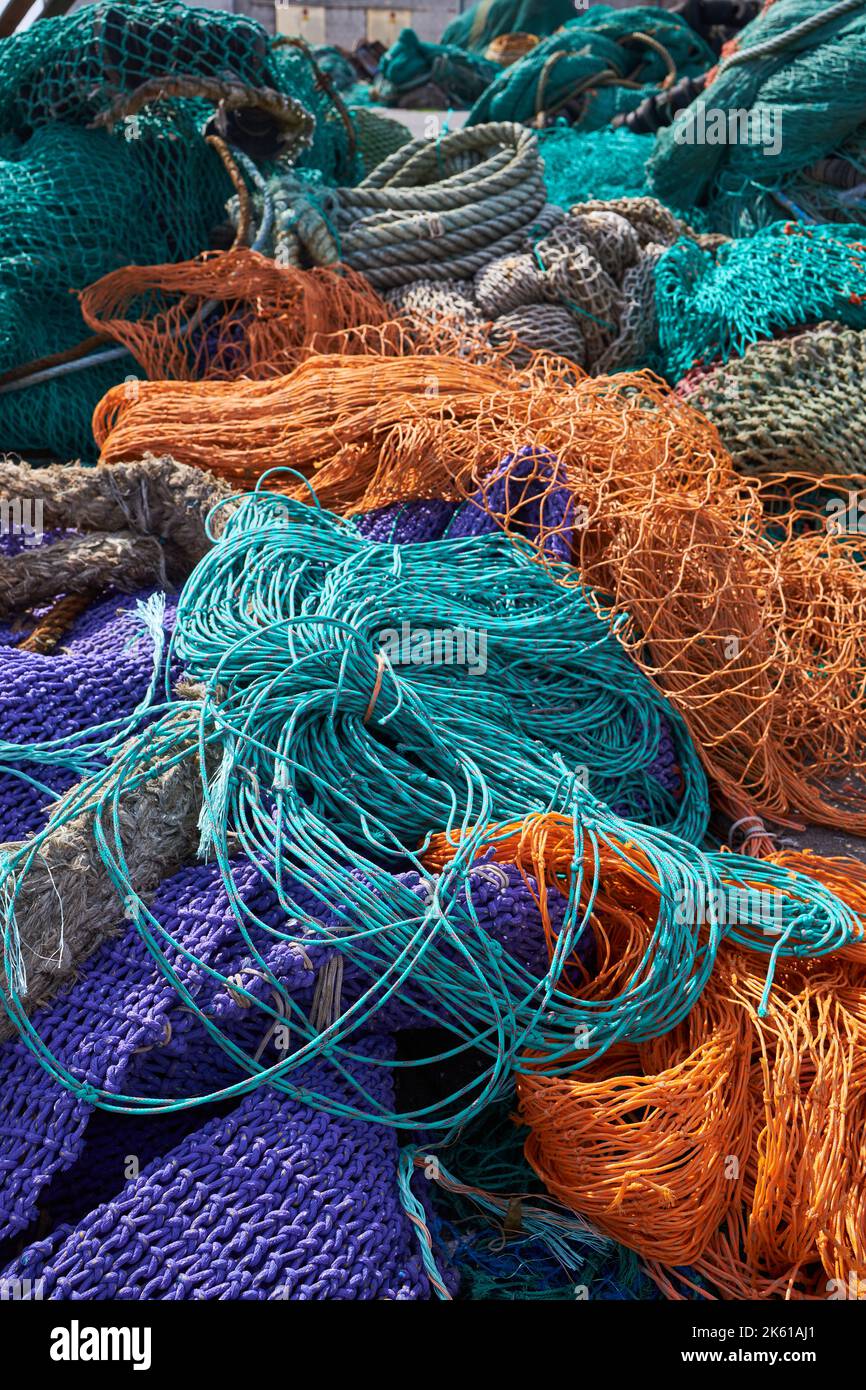 Bunch of fishing colorful nets in daytime in port Stock Photo - Alamy