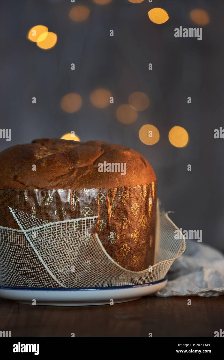 Uncut fresh baked artisan Christmas panettone cake under warm light ...