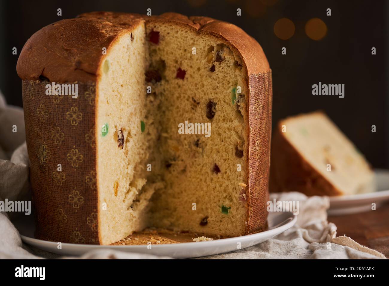 Sliced fresh baked artisan Christmas panettone cake under warm light ...