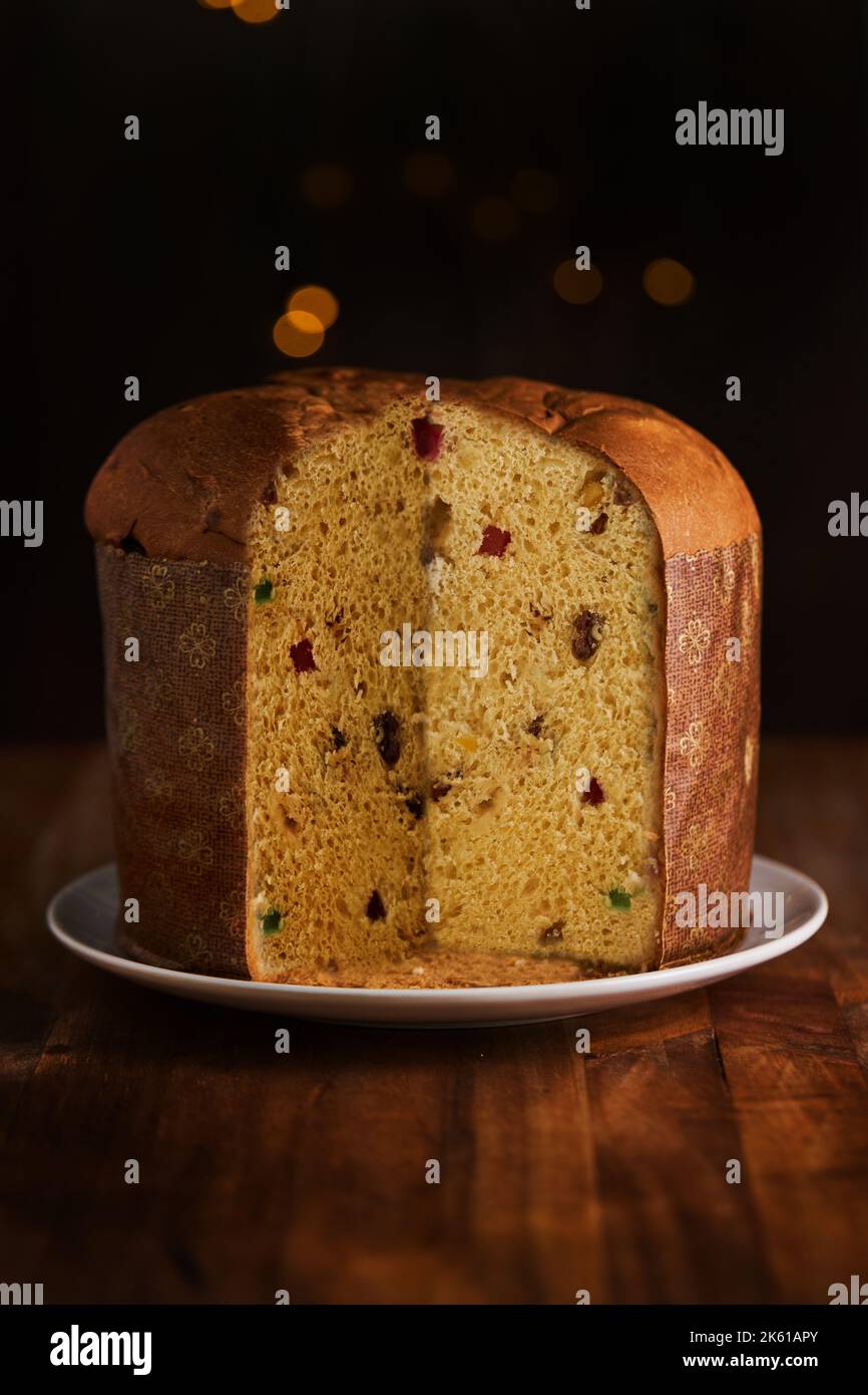 Sliced fresh baked artisan Christmas panettone cake under warm light ...