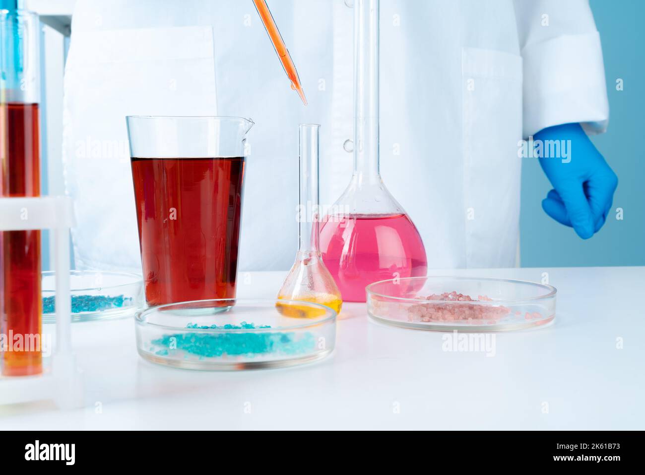 Manipulations with laboratory glass chemical containers on table Stock ...