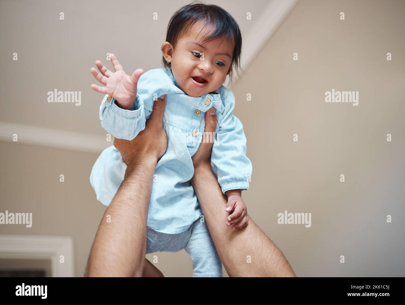 Love, family and baby with down syndrome playing and having fun with ...