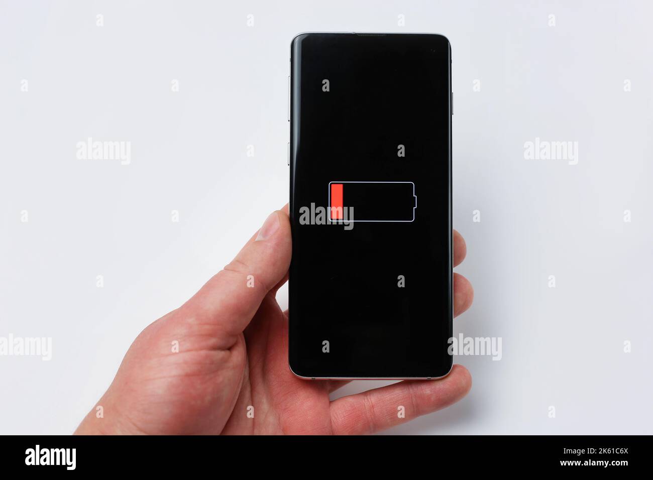 Smartphone in hand with low battery Stock Photo - Alamy