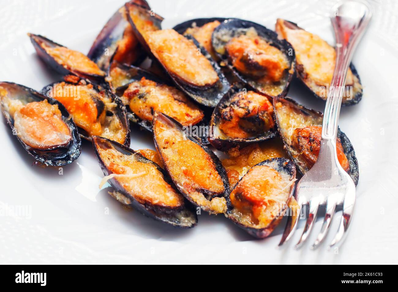 Sauteed mussels with cheese, appetizer typical for Puglia, Italy Stock ...