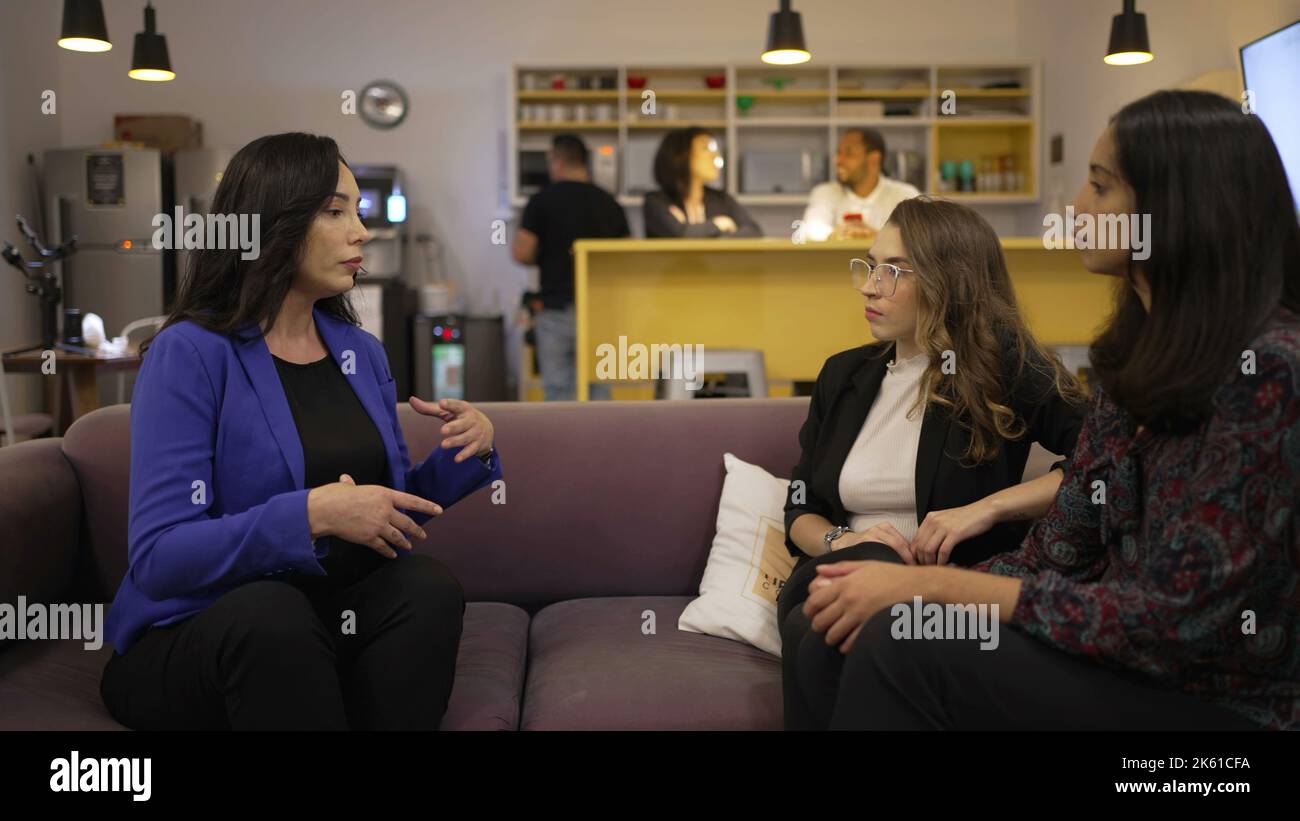Female executive coaching staff at kitchen resting room at workplace ...