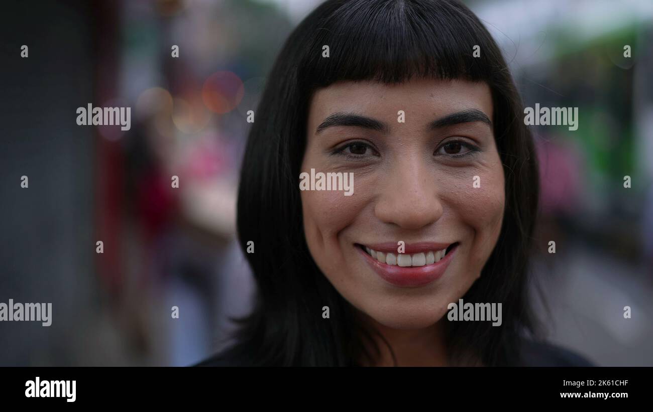 Contemplative young hispanic woman closing eyes in street. South ...