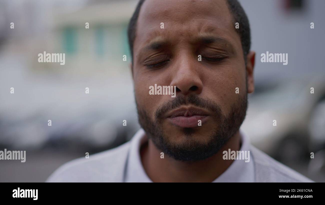 One anxious young African American man in distress closeup face ...