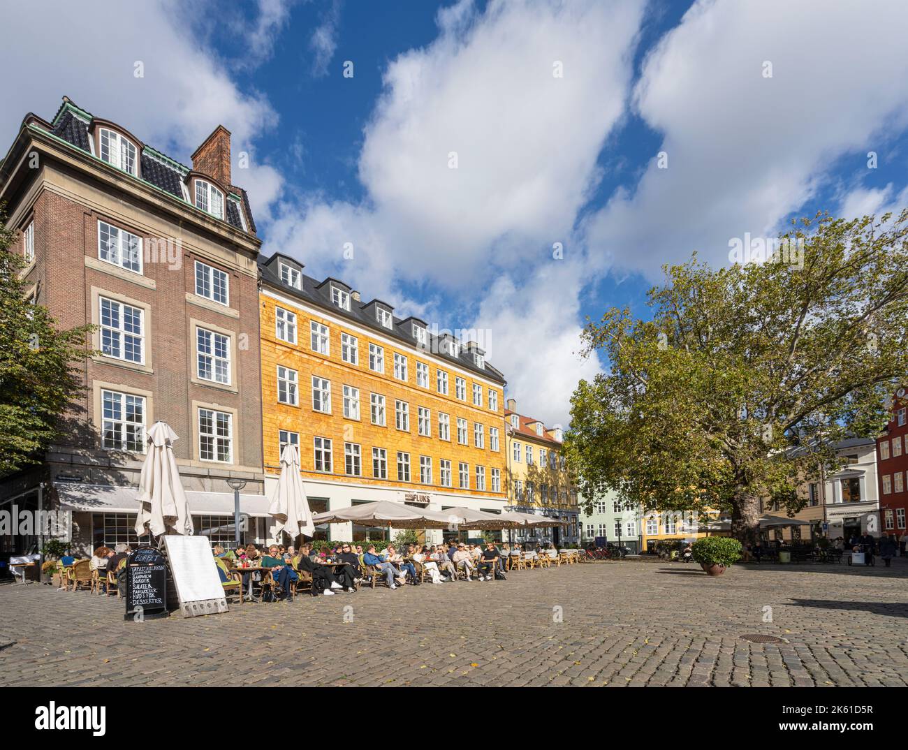 Copenhagen, Denmark. October 2022. people relax sitting in the sun in a ...