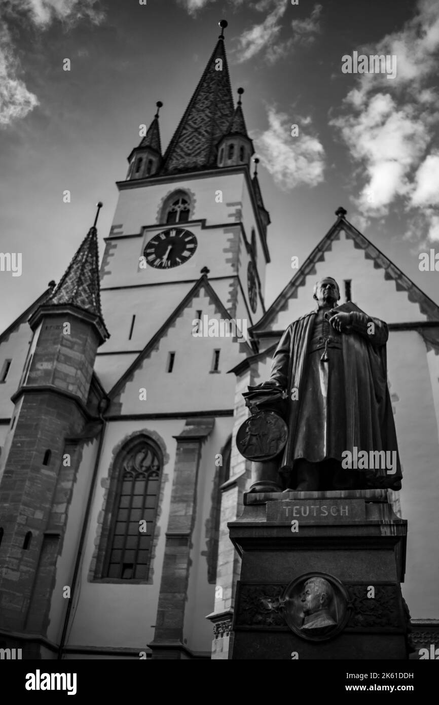 A greyscale shot of Protestant parish church and statue of Friedrich ...