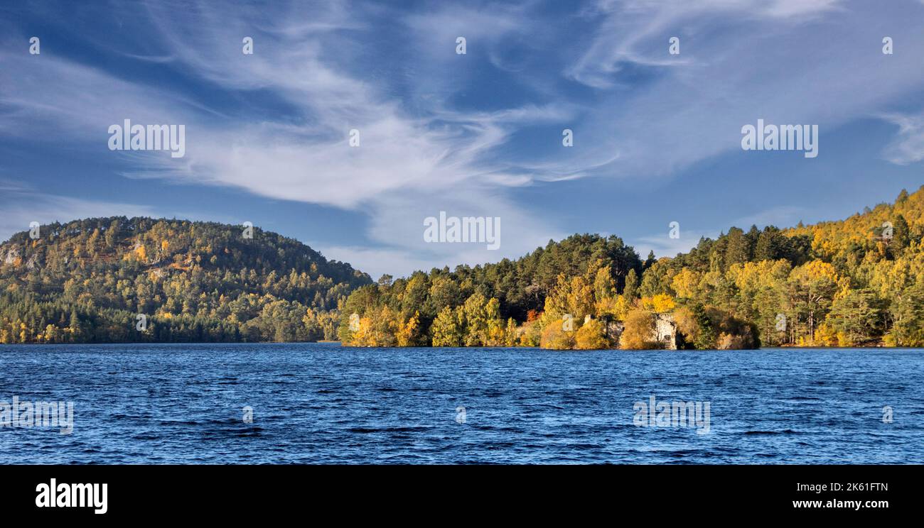 Loch an Eilein Aviemore Scotland a blue sky and trees in autumn colours ...