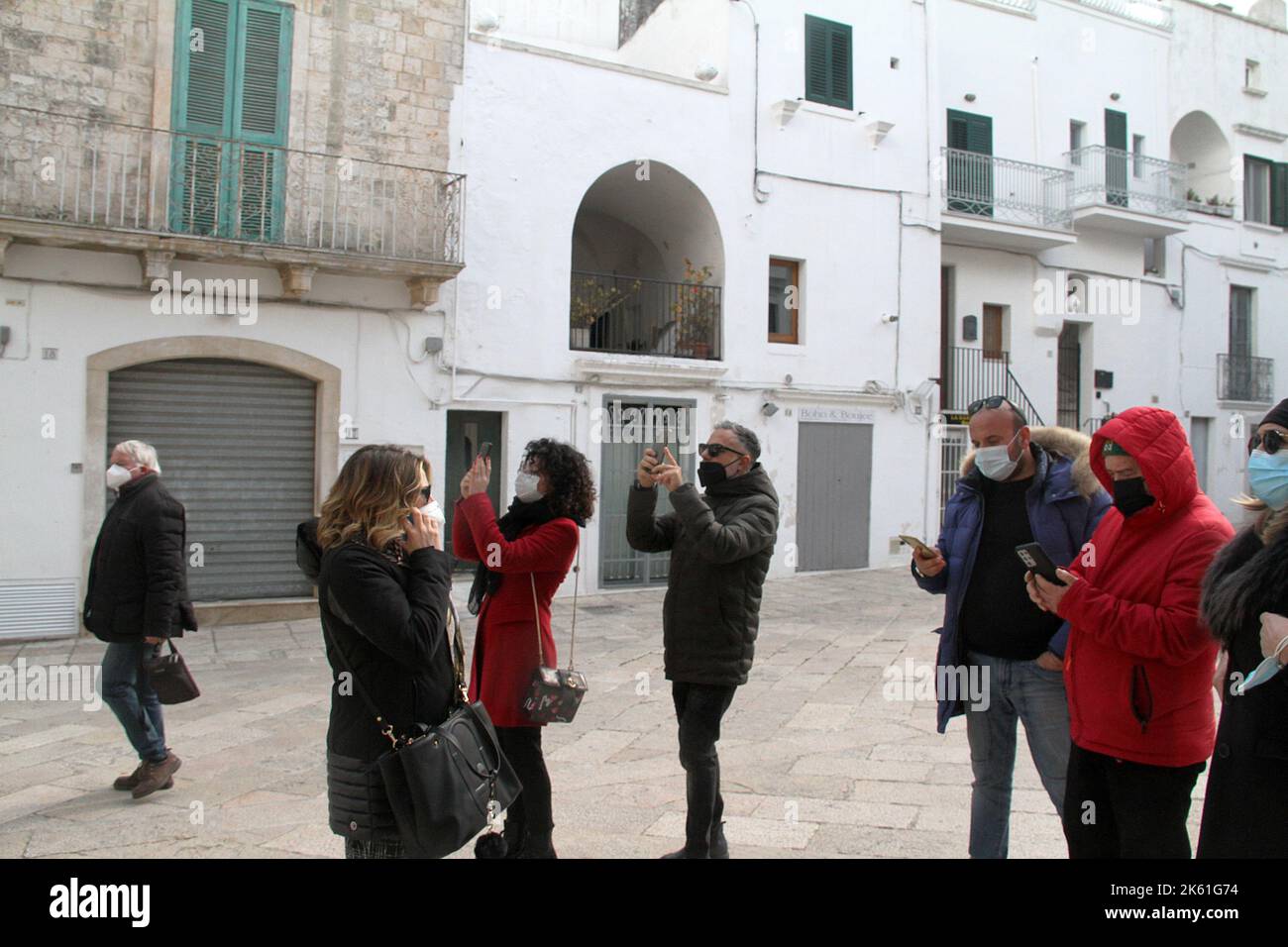 Cisternino, Puglia, Italy, February 2022. Tourists in the historical ...
