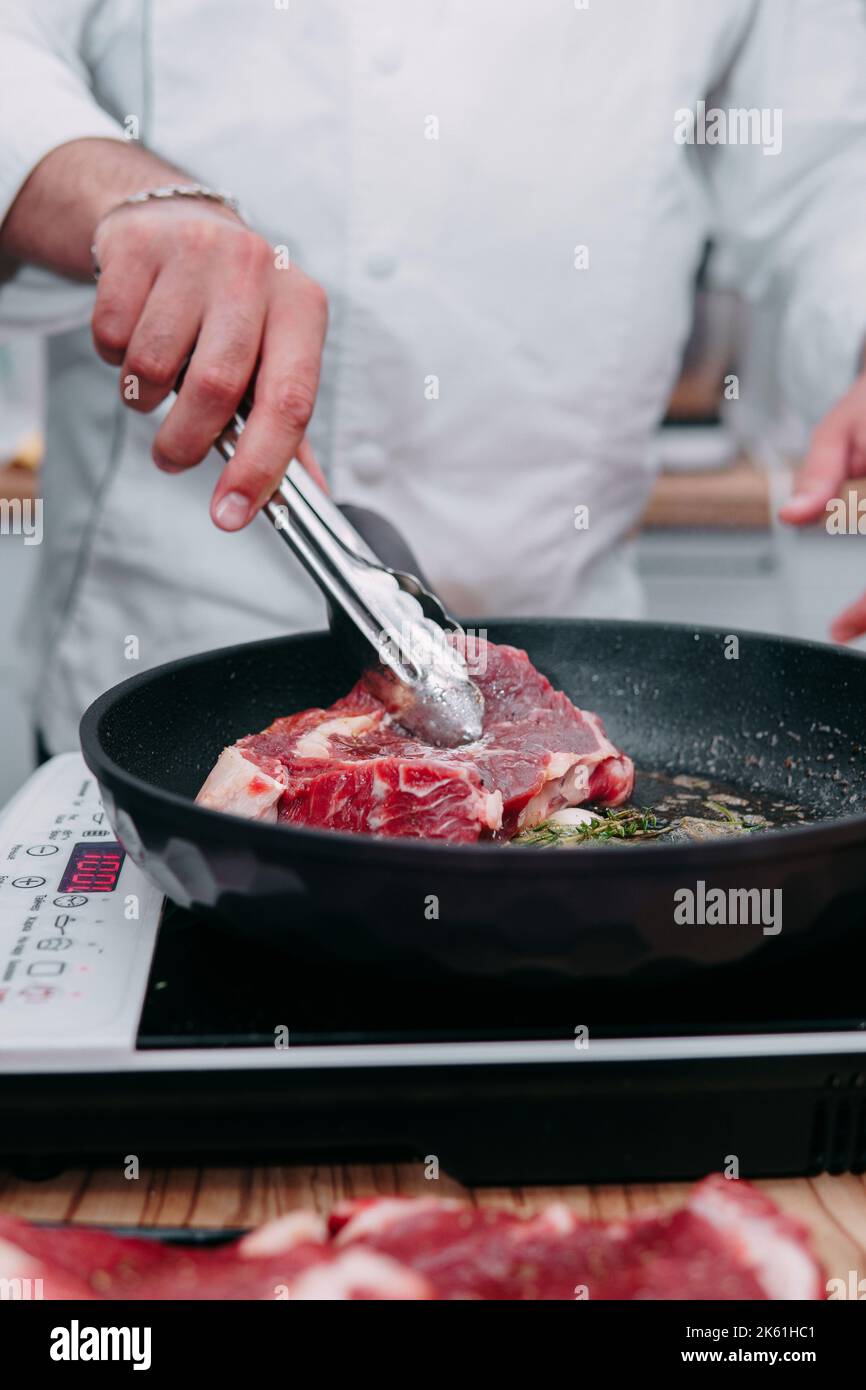 cooking steaks in a pan. cooking beef at the culinary master class. the ...