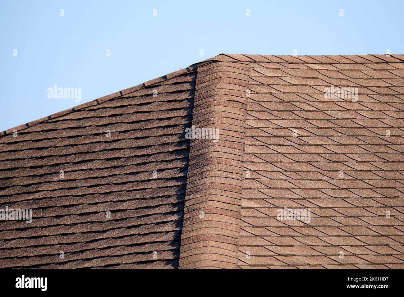 Closeup of house roof top covered with asphalt or bitumen shingles ...