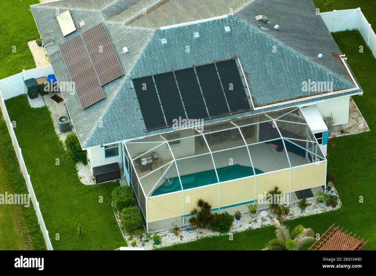 Aerial view of regular american home roof with blue solar photovoltaic ...