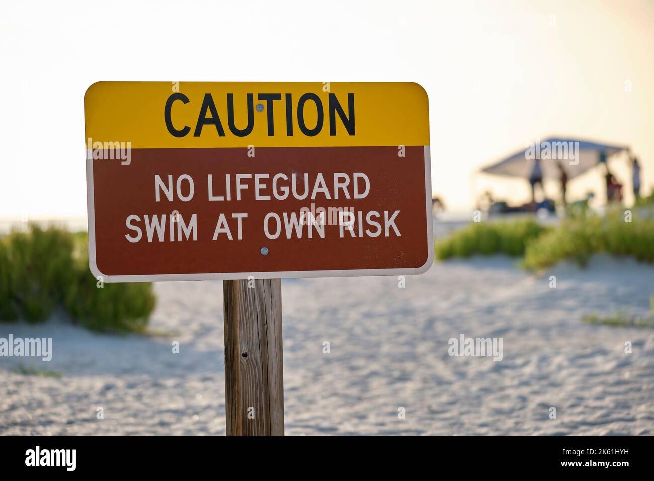 Warning sign poster on sea side beach saying that there is no lifeguard ...