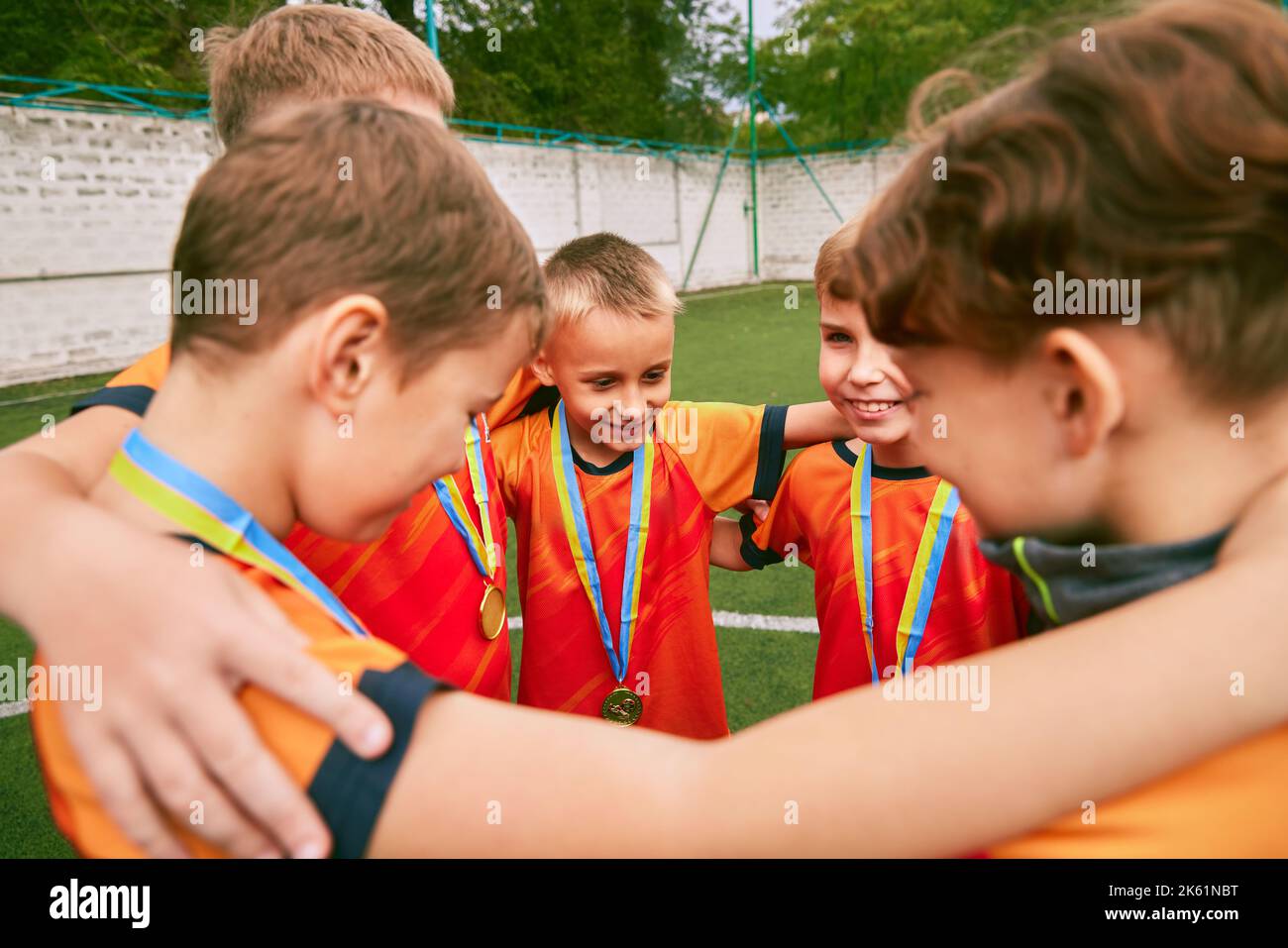 Support, motivation. Children, junior soccer team standing together in ...
