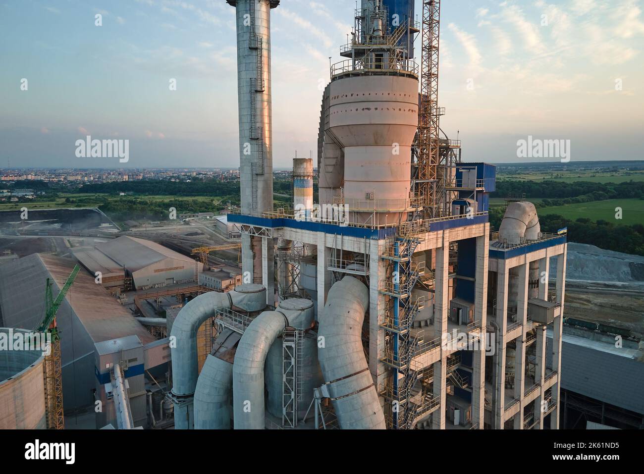 Cement plant with high factory structure and tower cranes at industrial ...
