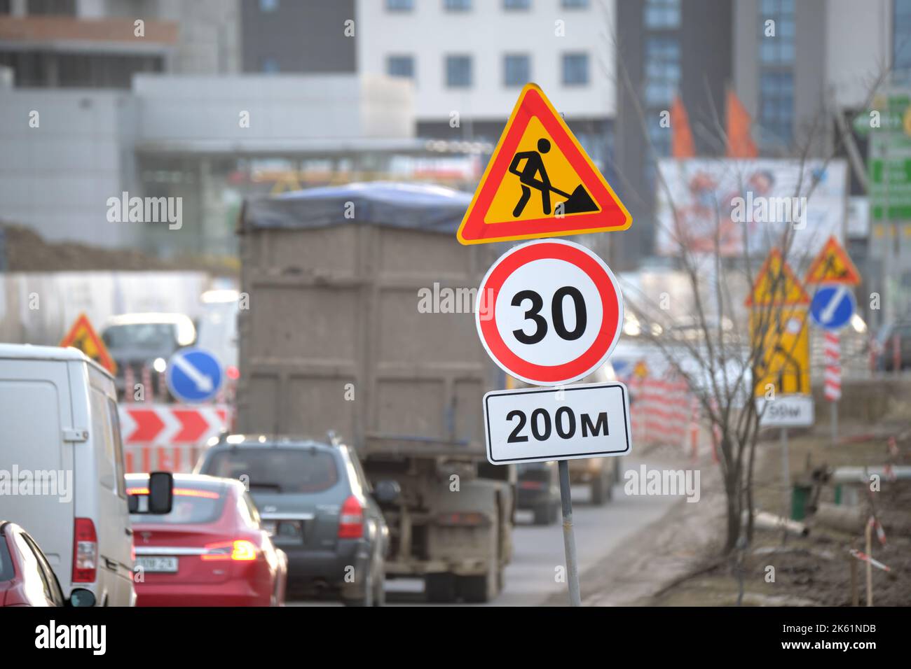 Roadworks warning traffic signs of construction work on city street and ...