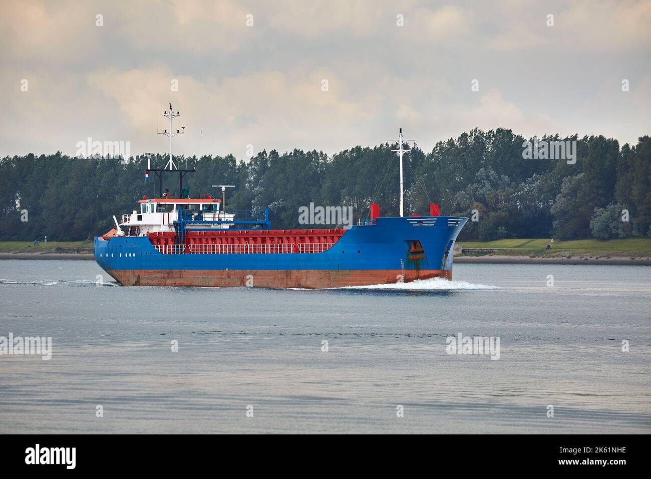 Ship carrying cargo on a river Stock Photo - Alamy
