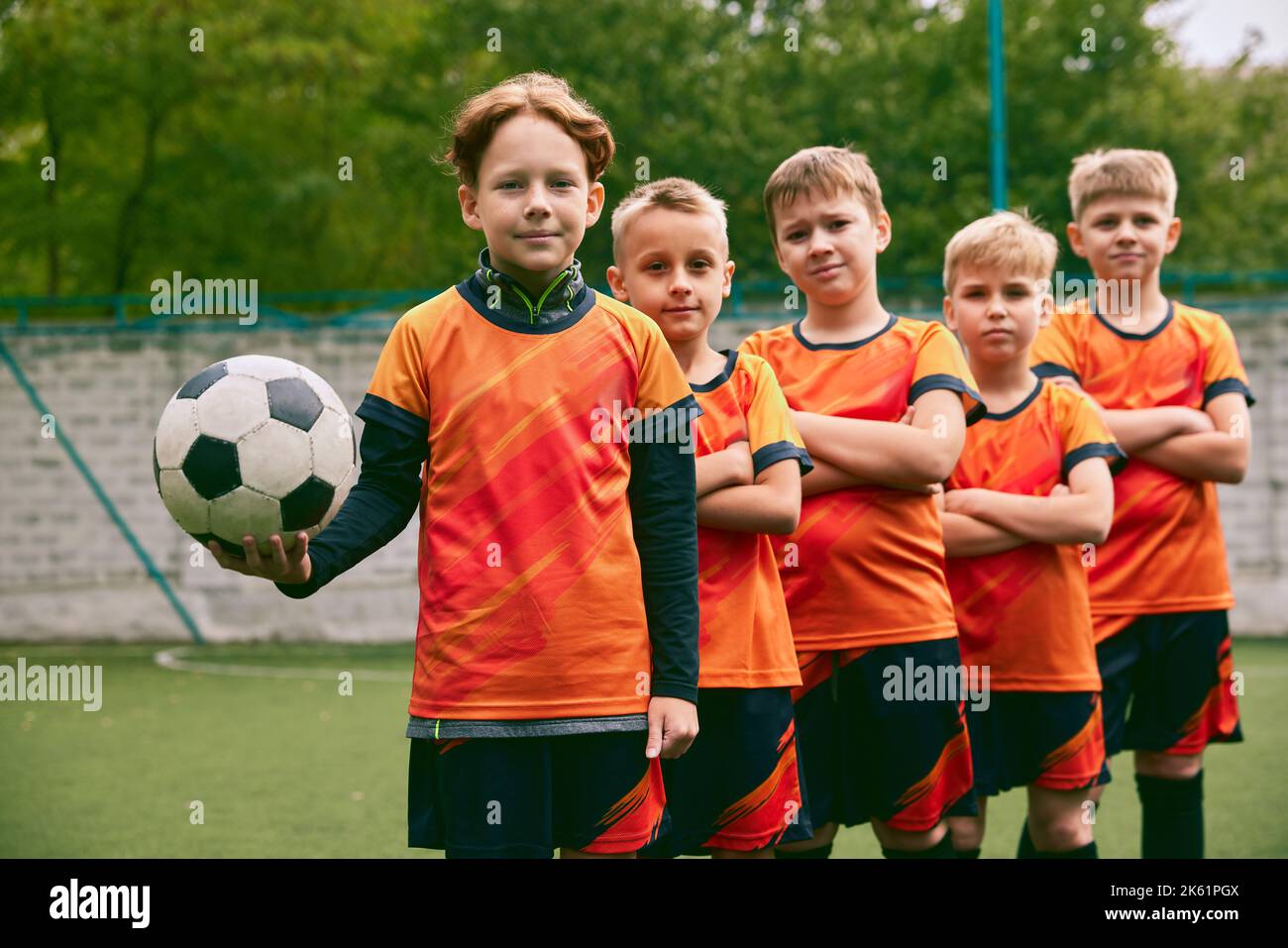 Teammates. Athletic boys in junior soccer team standing together at ...