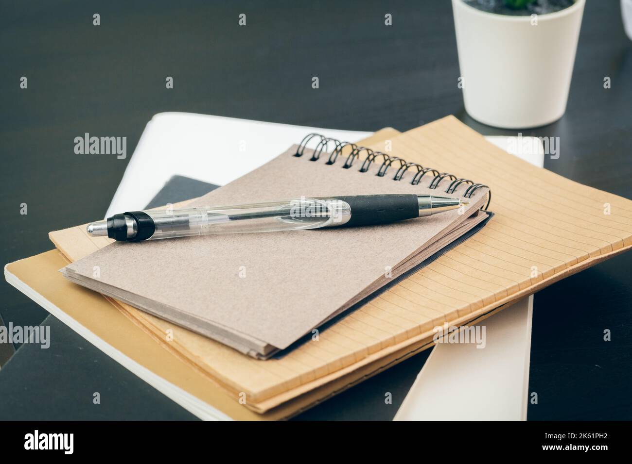 Pen and notebook up close on an office desk Stock Photo - Alamy