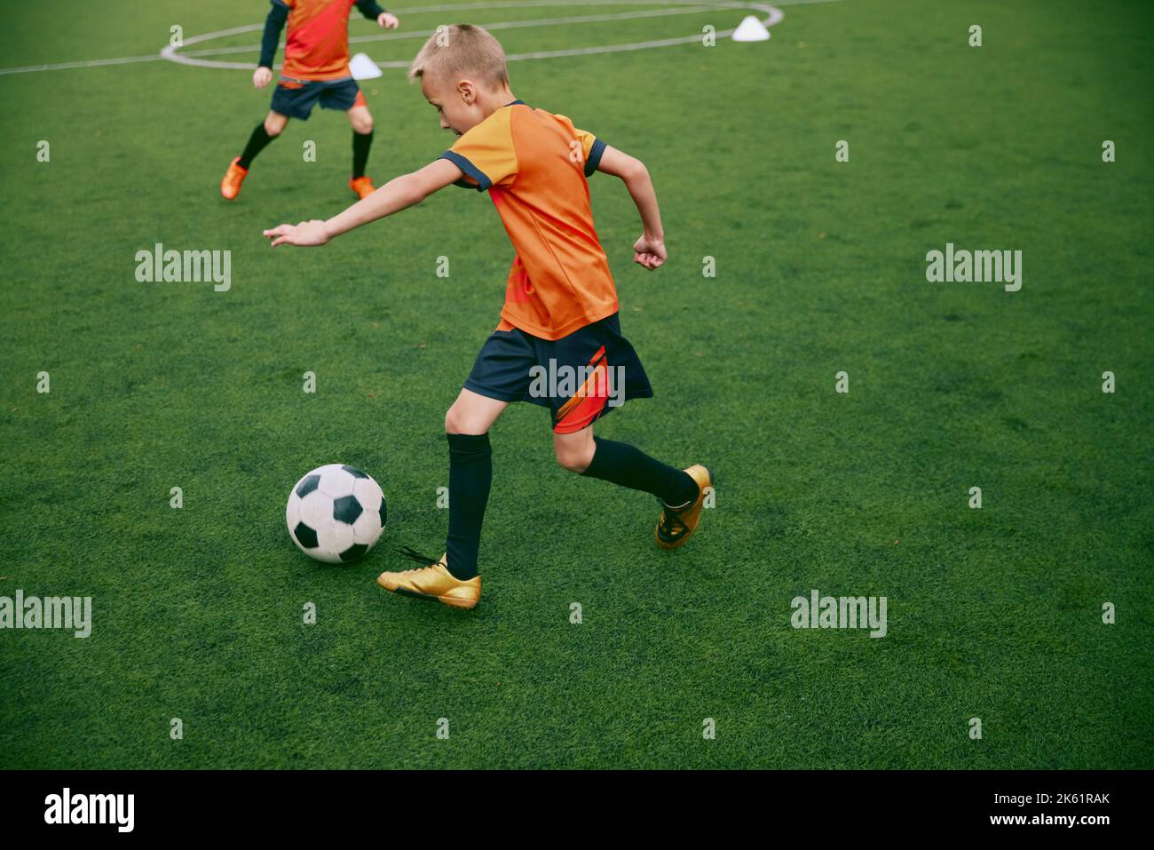 Workout. Junior soccer team playing football at sports stadium ...