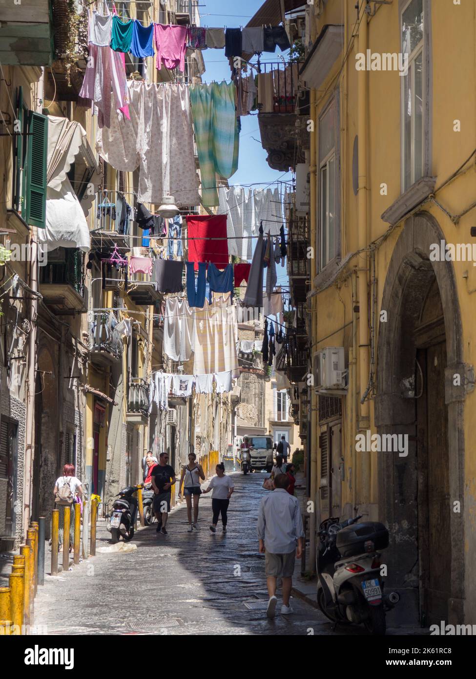 The narrow streets of Naples with the clothes hanging between the ...