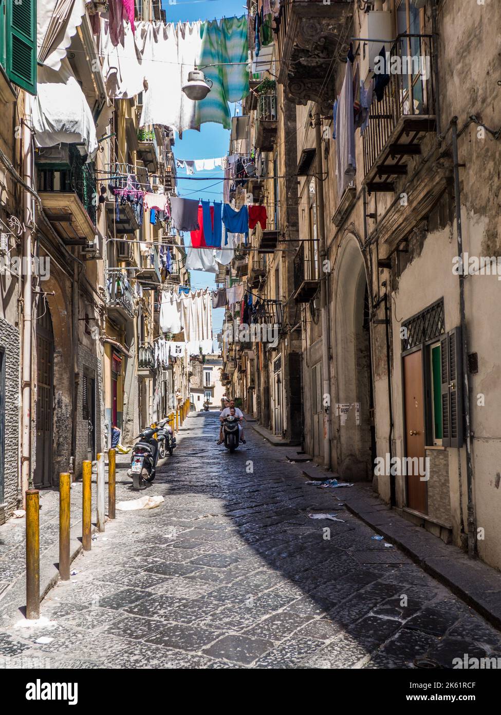 The narrow streets of Naples with the clothes hanging between the ...