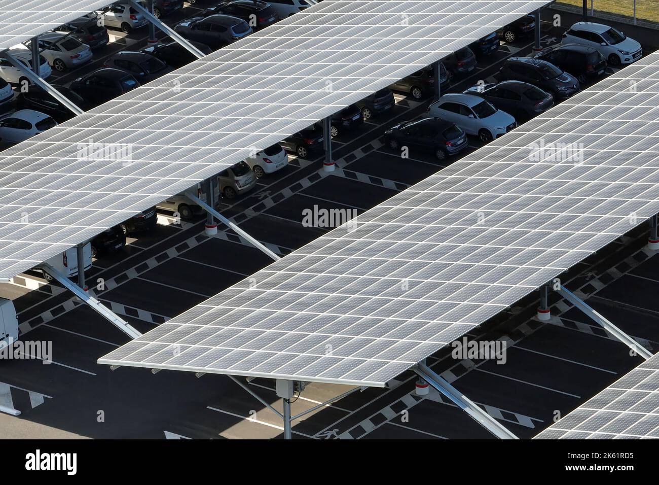 Aerial view of solar panels installed over parking lot with parked cars ...