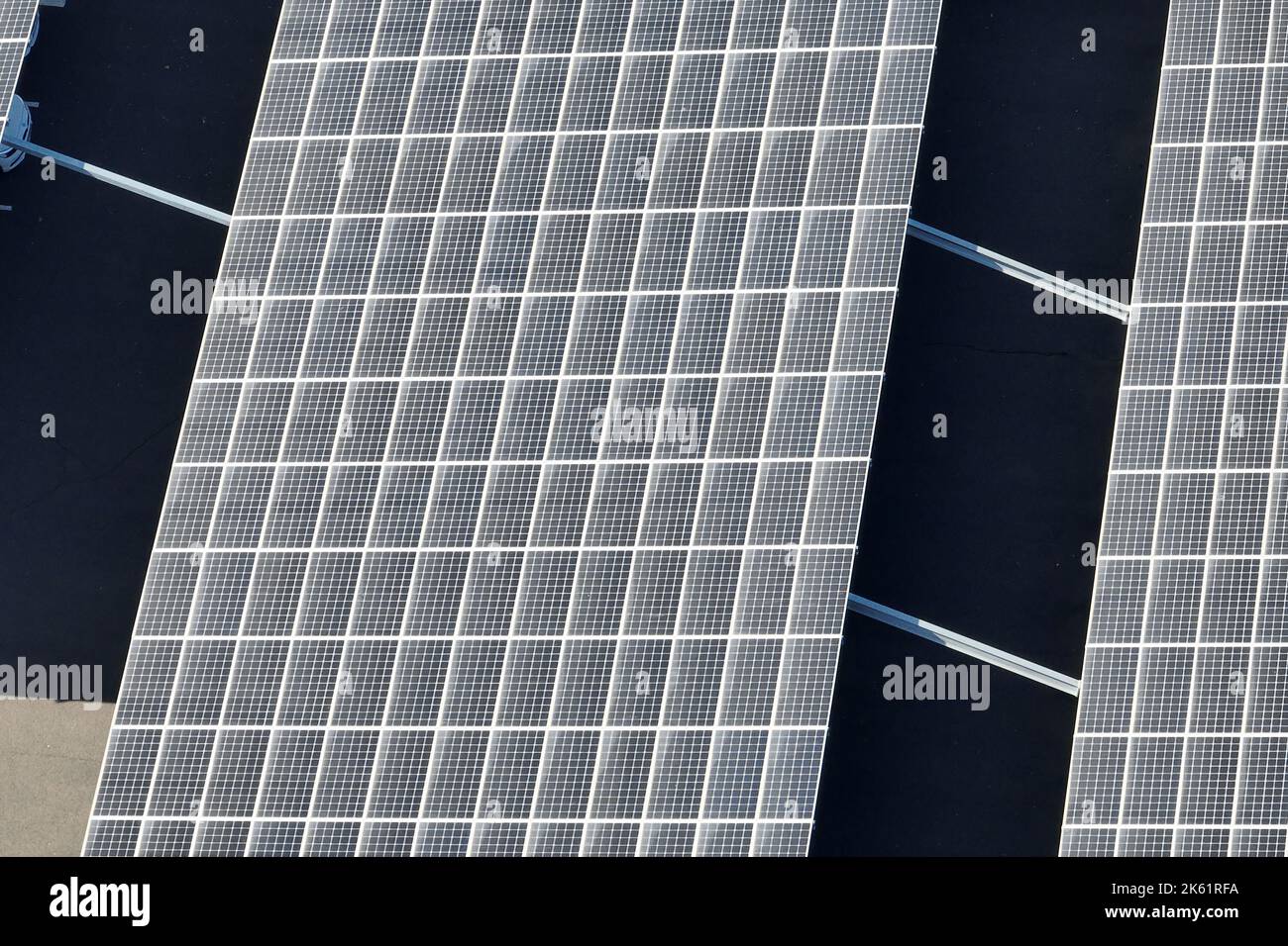 Aerial view of blue photovoltaic solar panels mounted on industrial ...