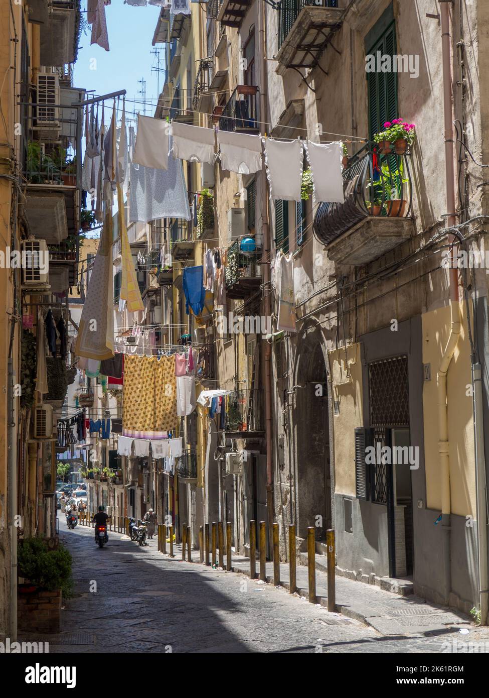 The narrow streets of Naples with the clothes hanging between the ...
