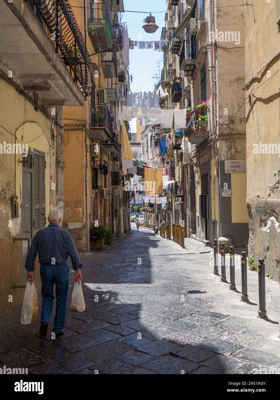 The narrow streets of Naples with the clothes hanging between the ...