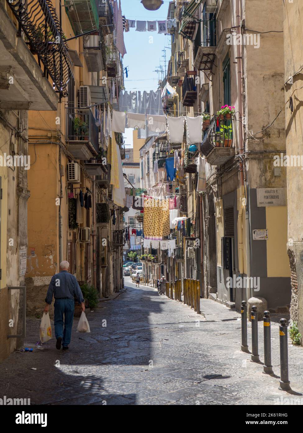 The narrow streets of Naples with the clothes hanging between the ...