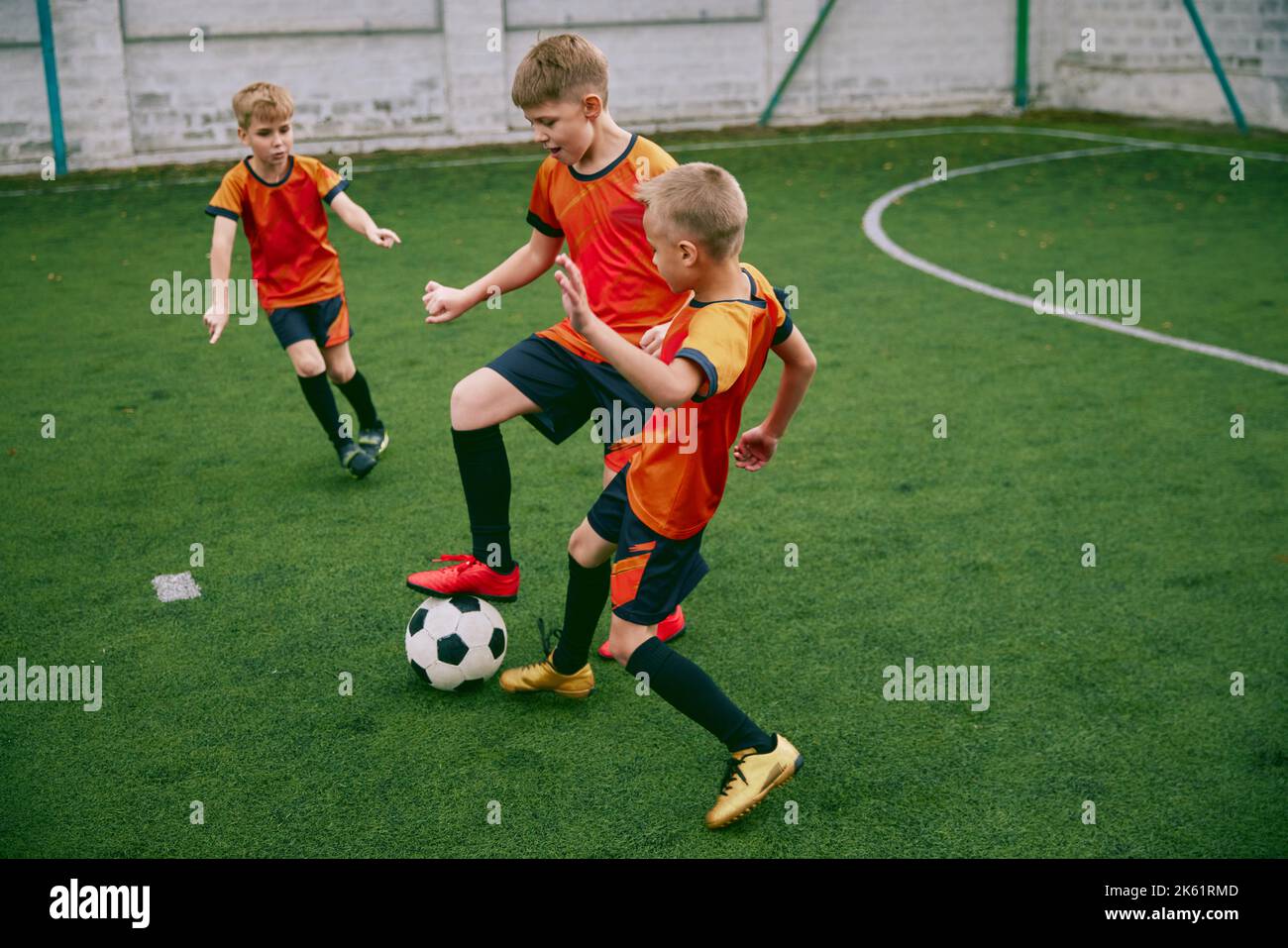 Workout. Junior soccer team playing football at sports stadium ...