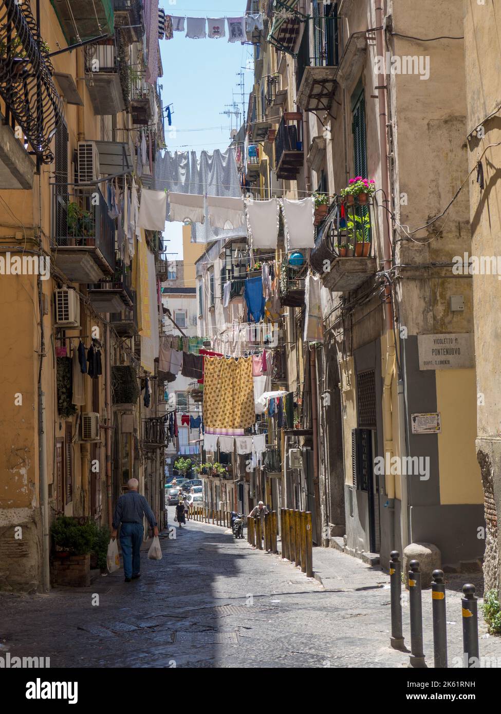 The narrow streets of Naples with the clothes hanging between the ...