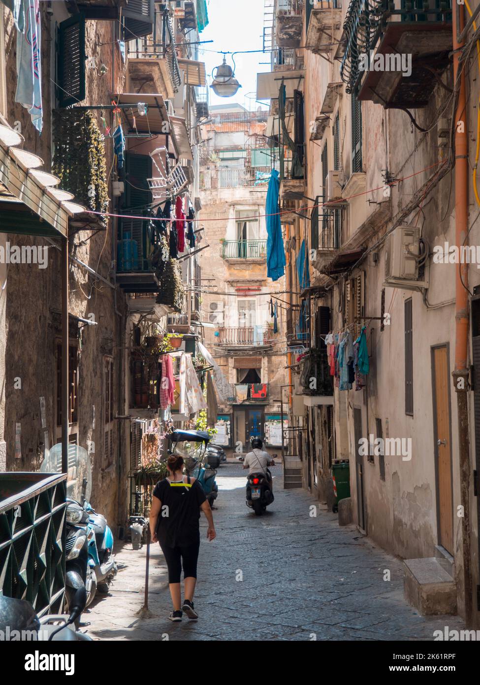 The narrow streets of Naples with the clothes hanging between the ...