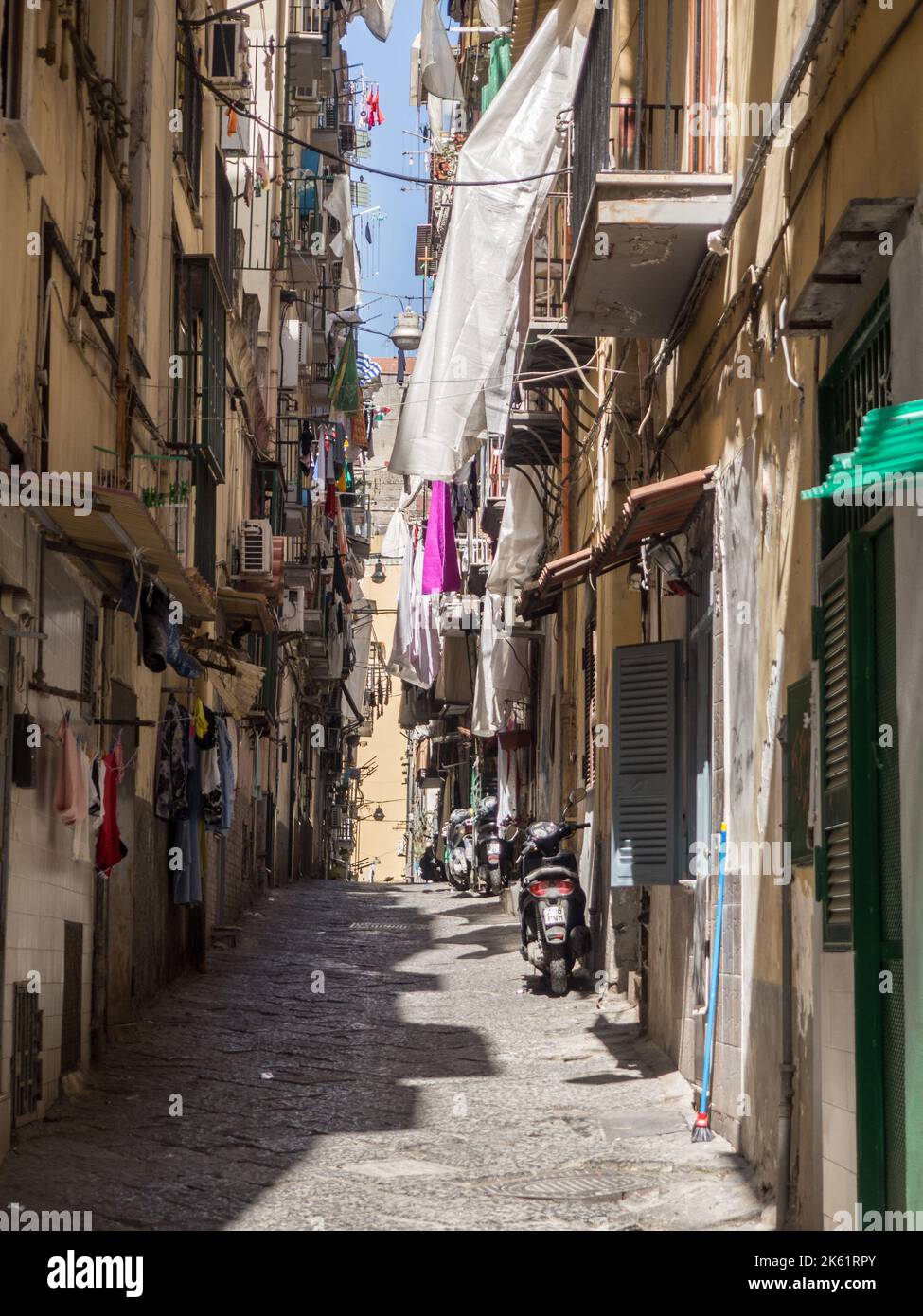 The narrow streets of Naples with the clothes hanging between the ...