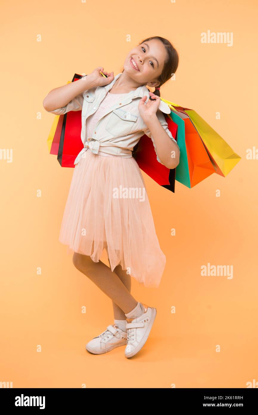kid in shop. happy kid in shop with bags. beautiful little kid girl in ...