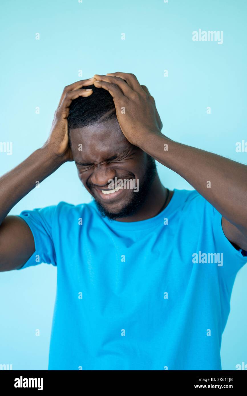 headache pain stress pressure man holding head Stock Photo - Alamy